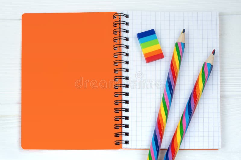 Open Copybook with Two Pencils and a Rubber on White Wooden Table Stock ...