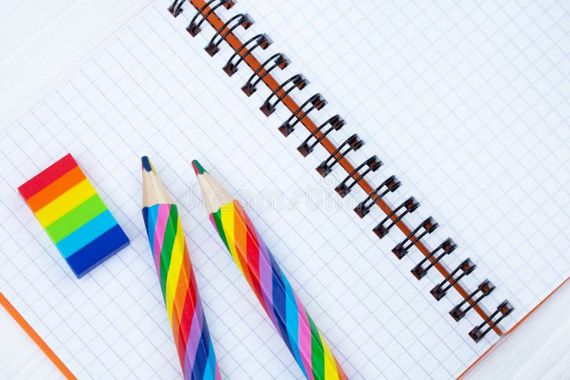 Open Copybook with Two Pencils and a Rubber on White Wooden Table Stock ...