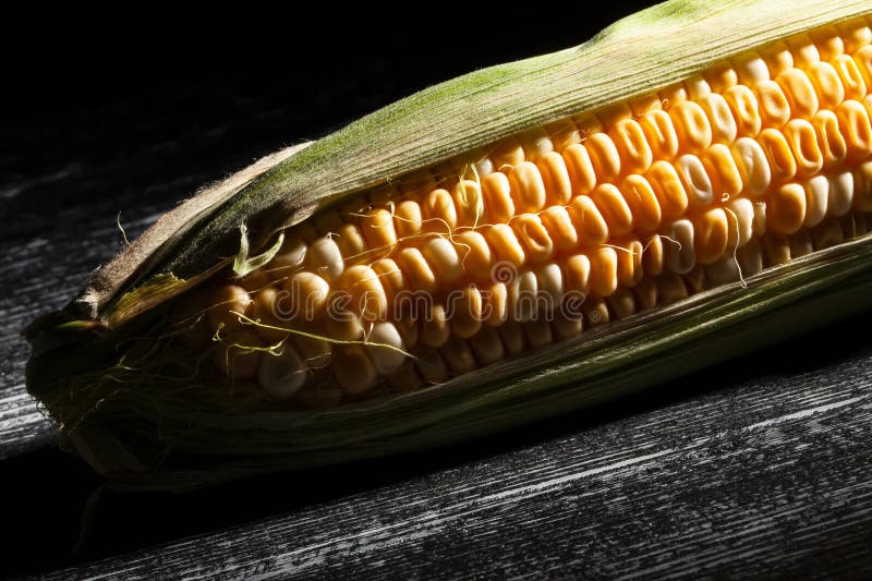 Open corn on black wood stock photo. Image of tasty - 368321266