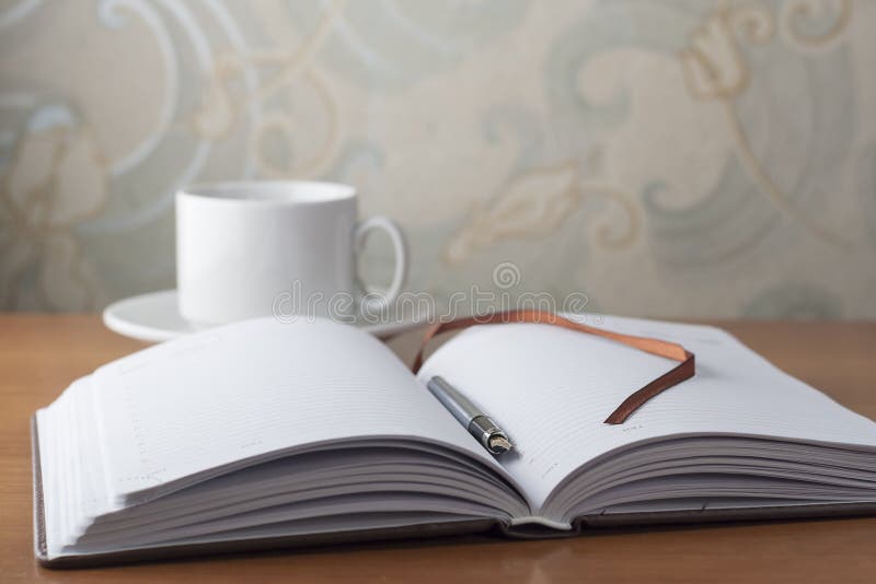 Open Diary and Pen Businessman Lying on a Wooden Table Next To a White ...