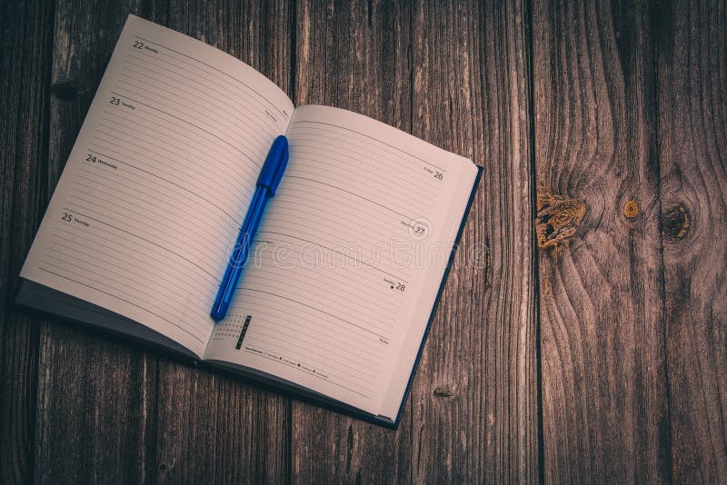 An Open Diary with a Pen Laid on a Rustic Wooden Desk Stock Photo ...