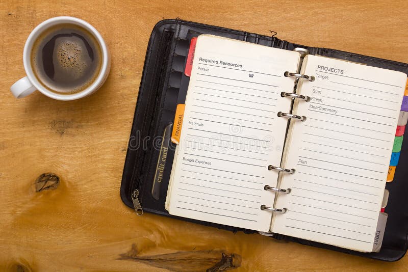 Open diary on wooden table stock image. Image of notepad - 66869727
