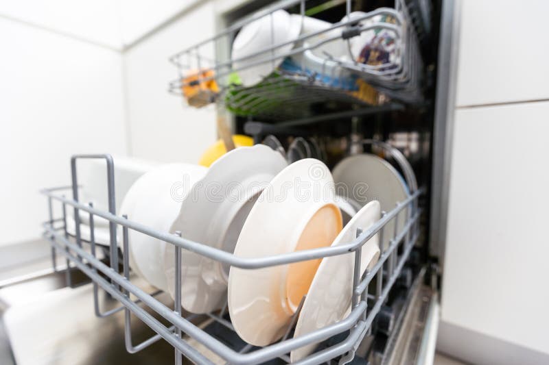 Open Dishwasher with Clean Dishes in the White Kitchen Stock Photo ...