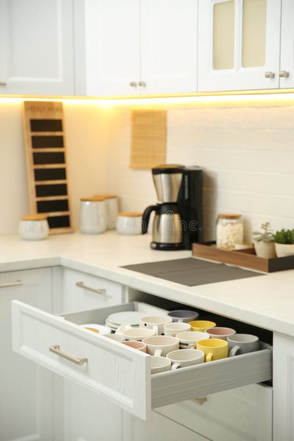 Drawer with Cups and Coffeemaker on Countertop in Kitchen Stock Photo ...