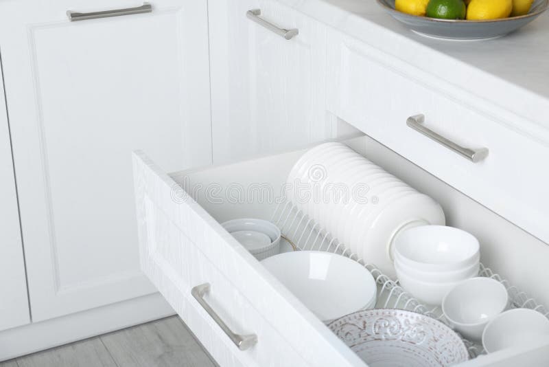 Open Drawer with Different Plates and Bowls in Kitchen Stock Photo ...