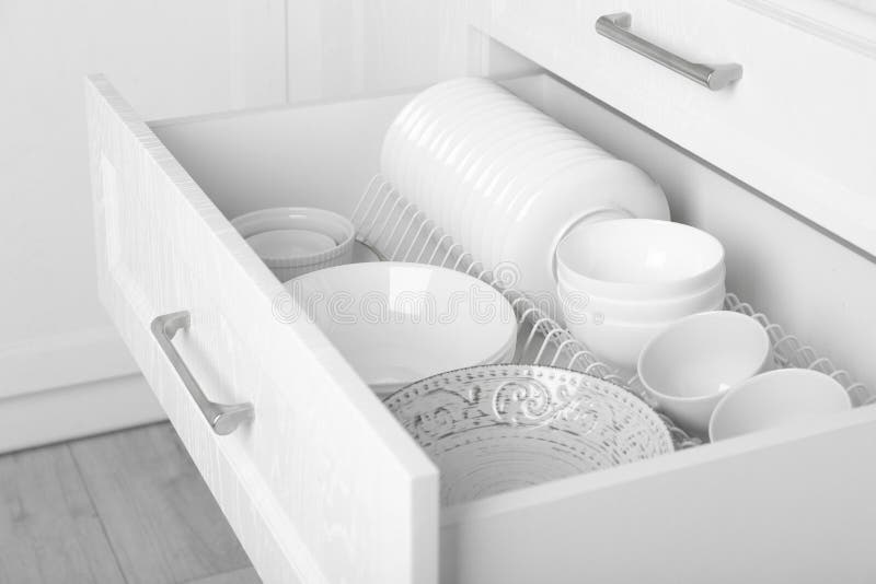Open Drawer with Different Plates and Bowls in Kitchen Stock Photo ...