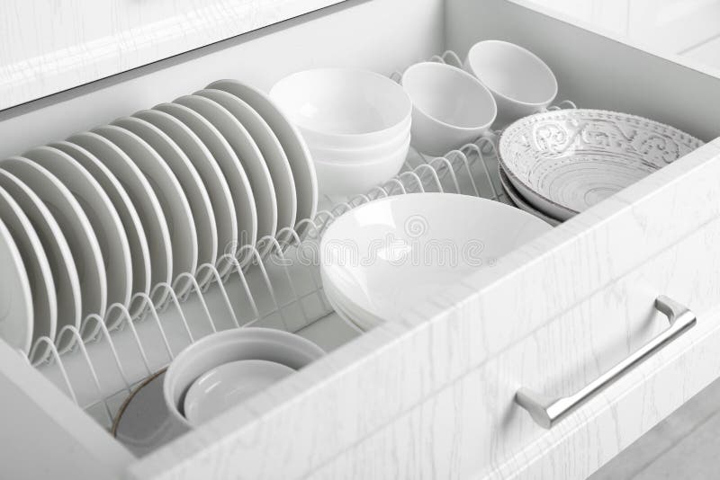 Open Drawer with Different Plates and Bowls in Kitchen, Closeup Stock ...