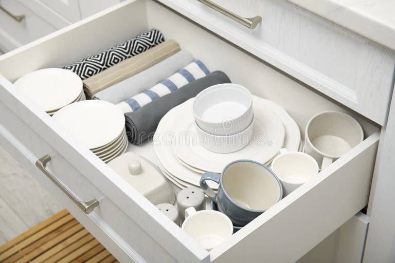 Open Drawer of Kitchen Cabinet with Different Dishware and Towels Stock ...