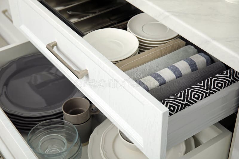 Open Drawers of Kitchen Cabinet with Dishware and Towels, Closeup Stock ...