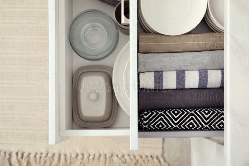 Open Drawers of Kitchen Cabinet with Different Dishware and Towels, Top ...