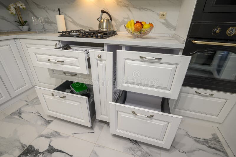 Open Drawers with Kitchenware at Modern White Kitchen Stock Photo ...