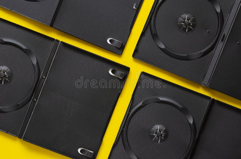 Open Empty DVD Boxes on a Yellow Background Stock Photo - Image of ...