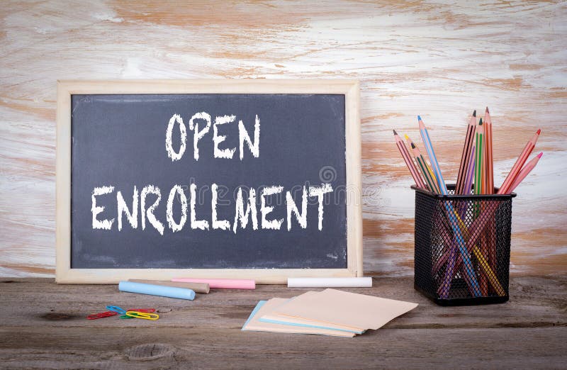 Open Enrollment Text on a Blackboard. Old Wooden Table with Text Stock ...
