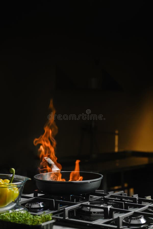 Open fire in a frying pan stock image. Image of preparation - 276070489