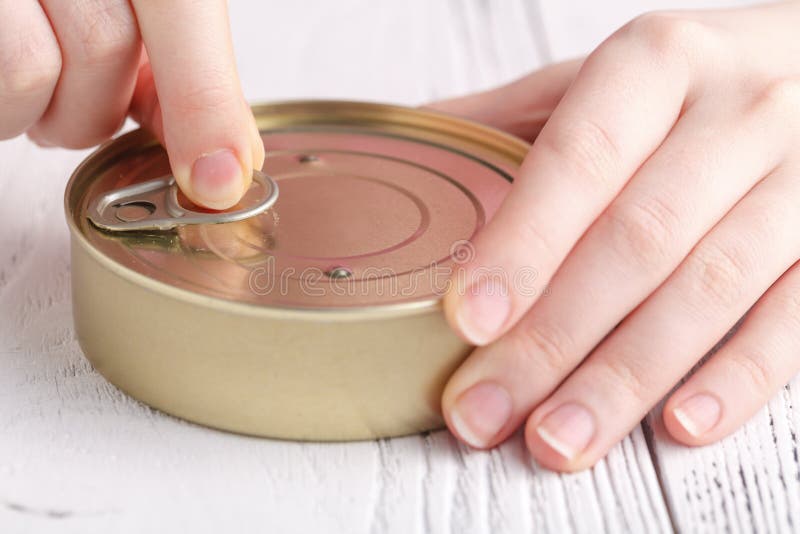 Open Fish Can with Hands and Fork on Table Stock Photo - Image of ...