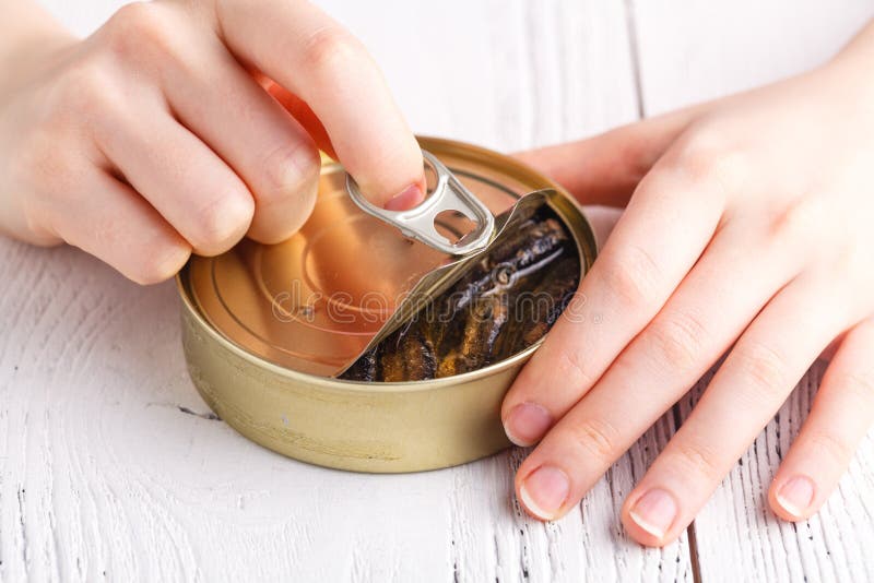 Open Fish Can with Hands and Fork on Table Stock Photo - Image of brown ...