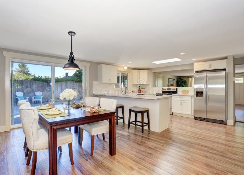 Open Floor Plan Dining Area with Elegant Table Setting and White Soft ...