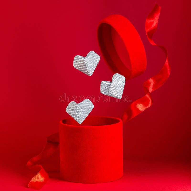 Open Flying Red Velvet Box with Red Silk Ribbon, Silver Hearts Fly from ...