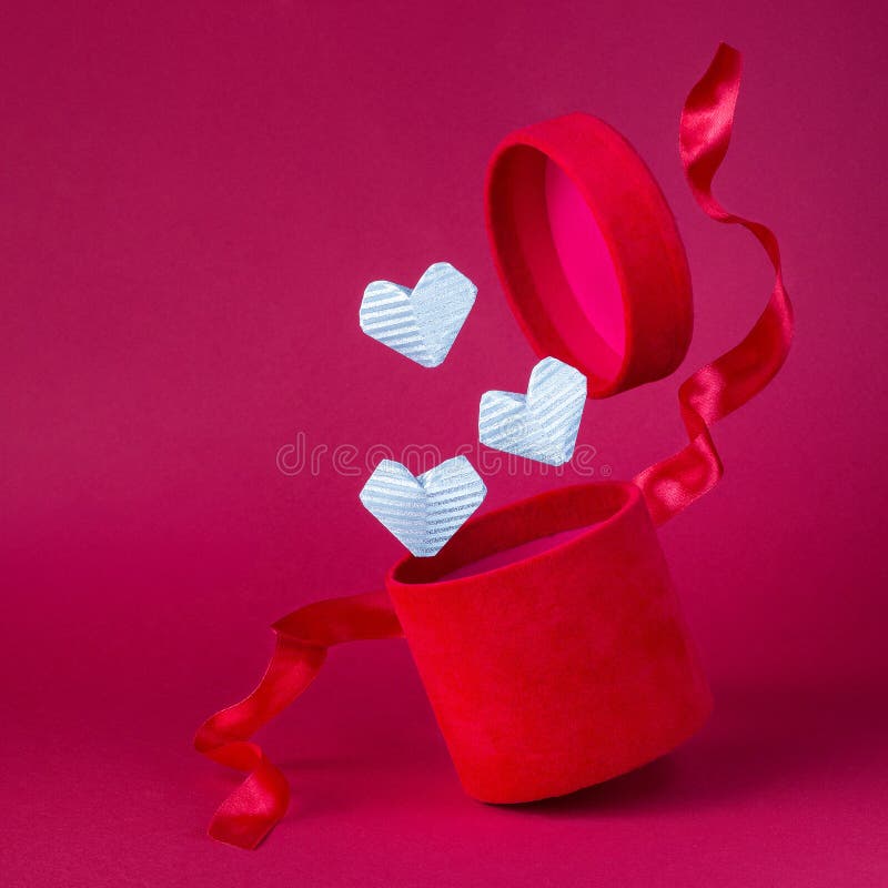 Open Flying Red Velvet Box with Red Silk Ribbon, Silver Hearts Fly from ...