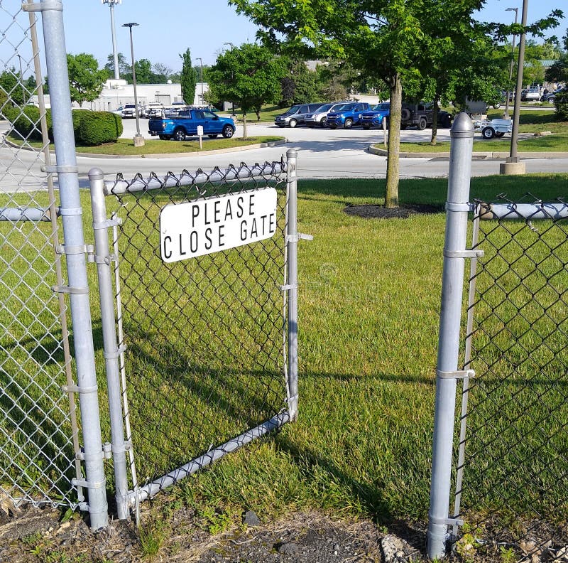 A Please Close the Gate Sign Hanging on a Rusty Metal Gate Stock Photo ...
