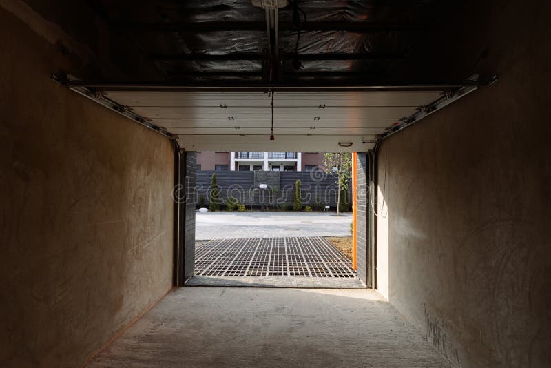 An Open Gate To an Empty, Spacious Garage in a Modern Cottage Stock ...