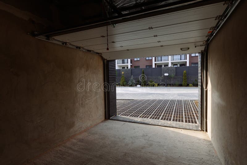 An Open Gate To an Empty, Spacious Garage in a Modern Cottage Stock ...
