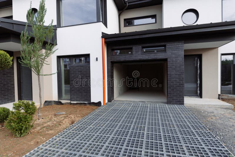 An Open Gate To an Empty, Spacious Garage in a Modern Cottage Stock ...