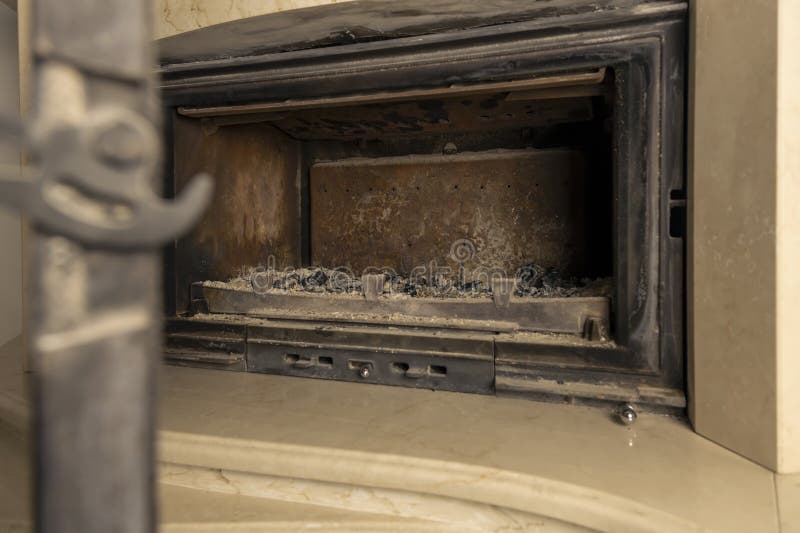 Open Glass Door of an Old Rusty Fireplace in a House. Focus on the ...