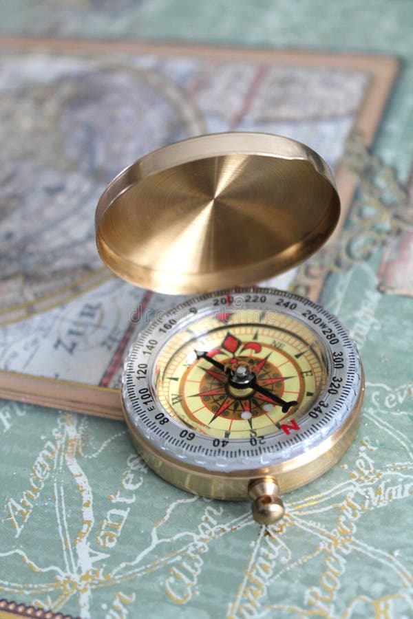 Gold Modern Compass on an Old Map Book Stock Photo - Image of open ...