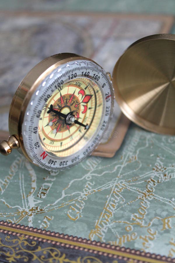 Gold Modern Compass on an Old Map Book Stock Image - Image of pioneer ...