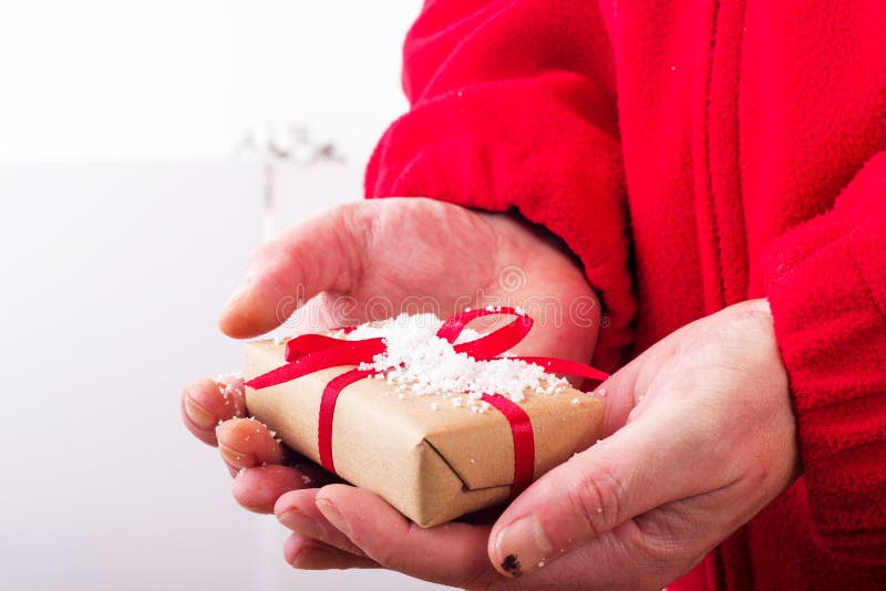 Open Hands Holding a Present Wrapped with a Red Ribbon Stock Photo ...