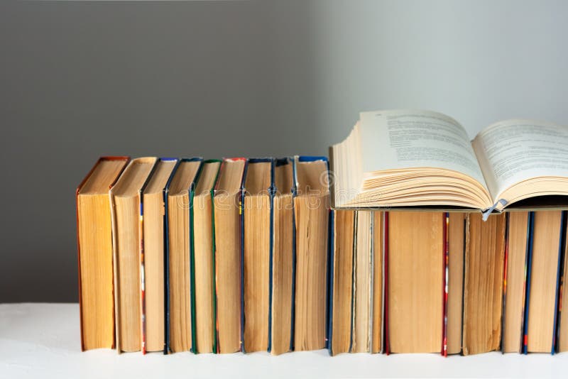 Open Hardback Book, Diary, Fanned Pages on Stack of Books on White ...