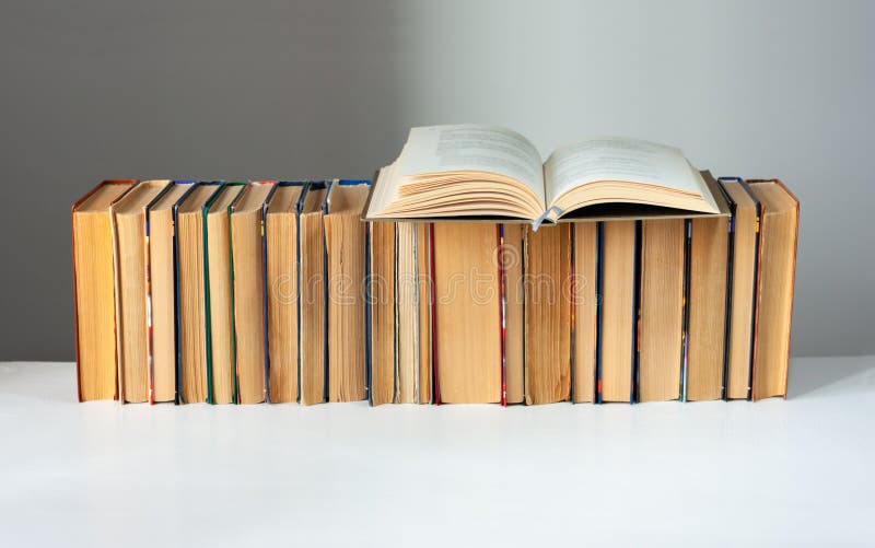 Open Hardback Book, Diary, Fanned Pages on Stack of Books on White ...