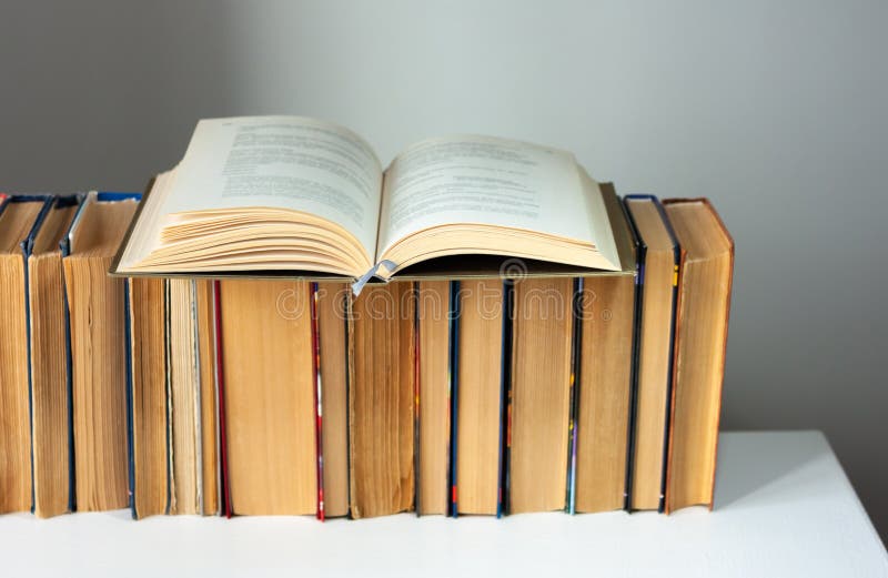 Open Hardback Book, Diary, Fanned Pages on Stack of Books on White ...