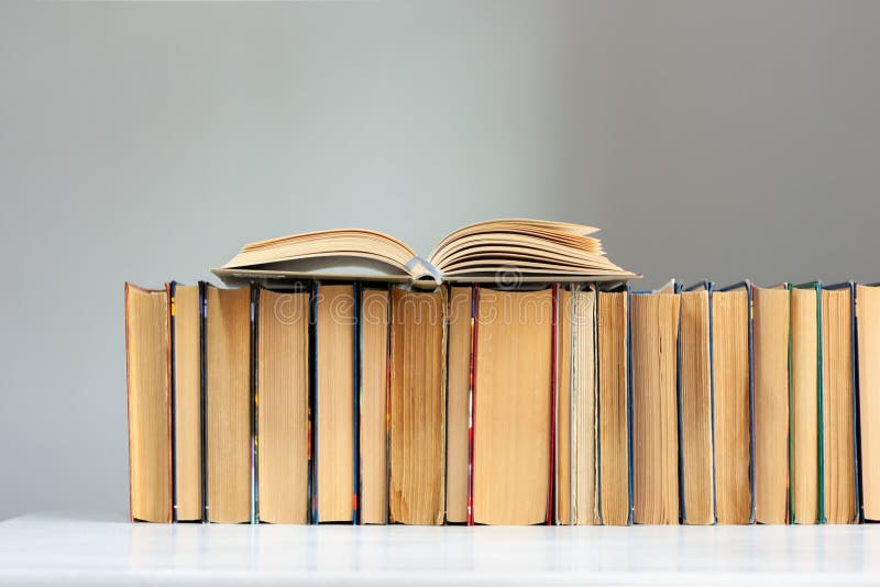 Open Hardback Book, Diary, Fanned Pages on Stack of Books on White ...