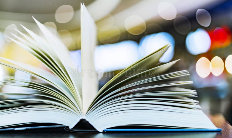 An Open Hardcover Book on a Table in a Public Library Stock Photo ...