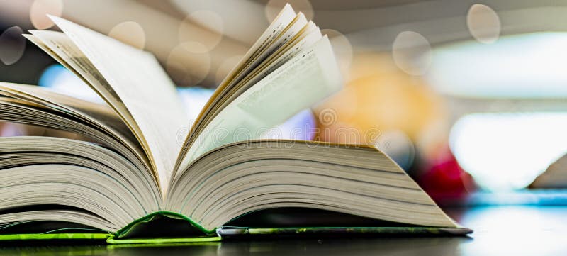 An Open Hardcover Book on a Table in a Public Library Stock Photo ...