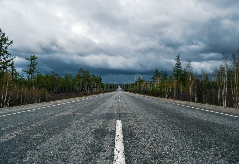 Expansive Highway Stretches into Distance Beneath Dramatic Stormy Sky ...