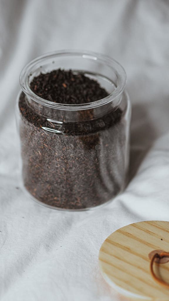 Open Jar of the Green Tea on the Soft White Bed, in a Vertical Shot ...