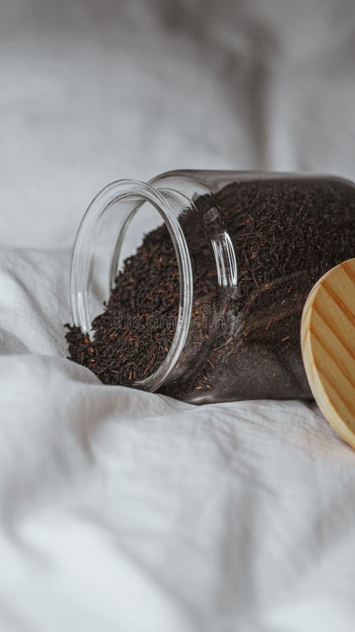 Open Jar of the Green Tea on the Soft White Bed, in a Vertical Shot ...
