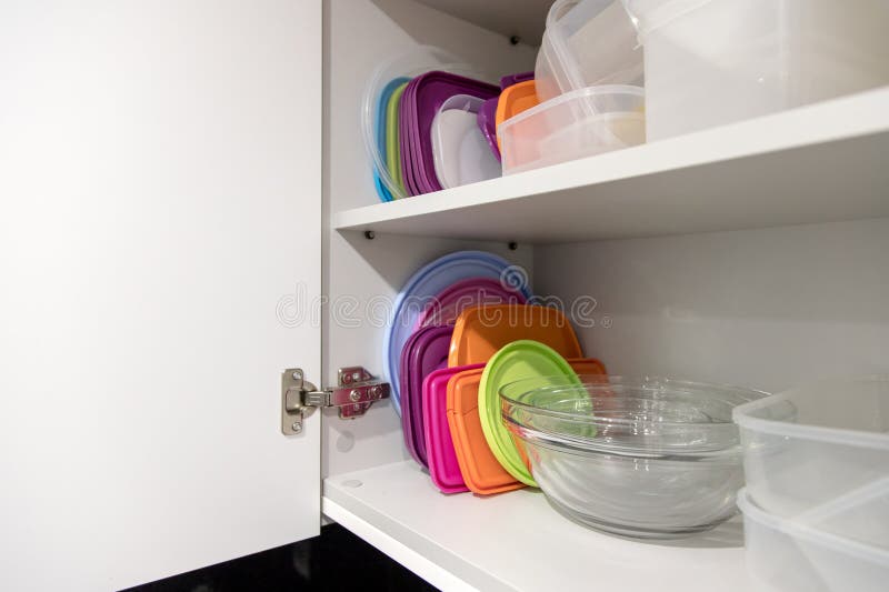 Open Kitchen Cupboard Full of Plastic and Glass Containers Inside ...
