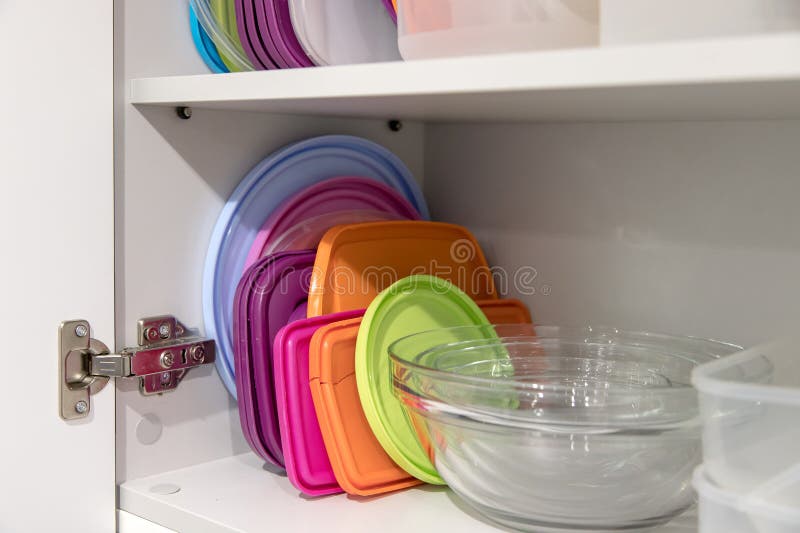 Open Kitchen Cupboard Full of Plastic and Glass Containers Inside ...