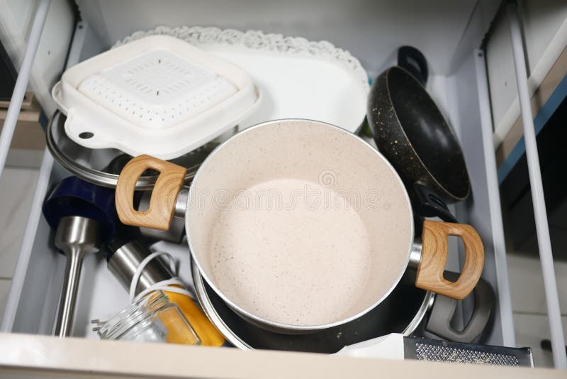 A Kitchen Drawer Full of Various Utensils and Cookware for Storage and ...