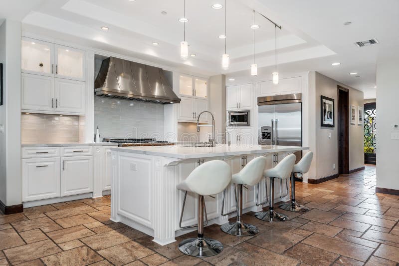An Open Kitchen with Four Bars and Stools in it Stock Photo - Image of ...