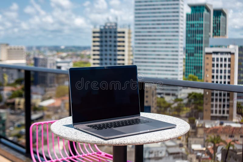 Open Laptop with a Black Screen on a Round Table on a Rooftop with a ...