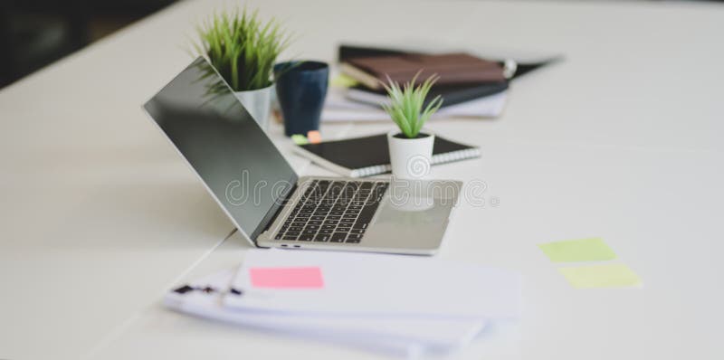 Open Laptop Computer with Office Supplies and Documents on White Table ...
