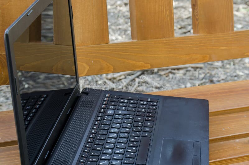 Open Laptop Computer on a Wooden Bench Stock Photo - Image of ...