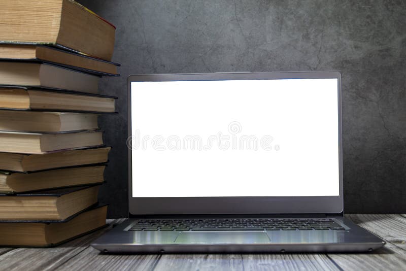 An Open Laptop on the Table Near the Stack of Books. Stock Photo ...