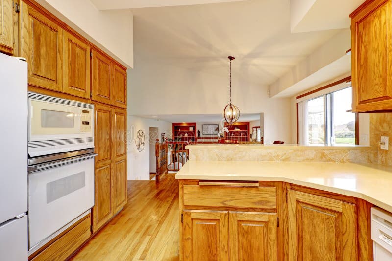 Open Large Kitchen Interior with Vaulted Ceiling and White Appliances ...