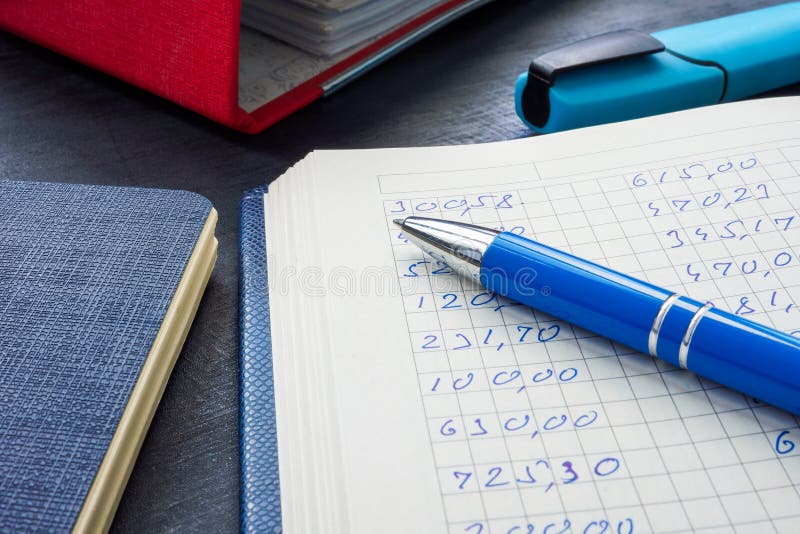 An Open Ledger with Financial Records, a Pen and a Folder. Stock Photo ...